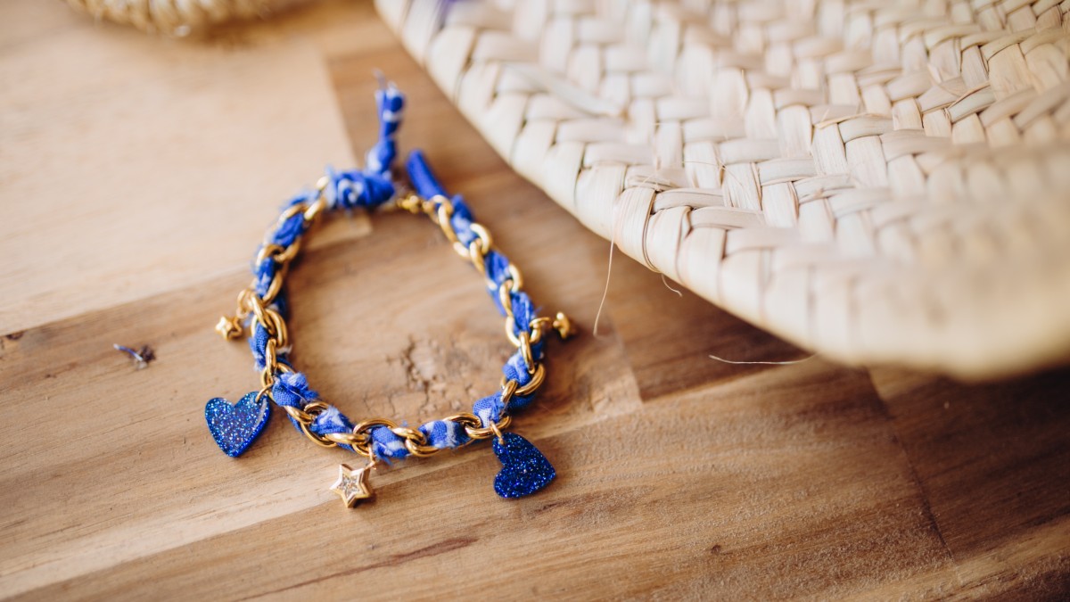 Gold chain bracelet and blue bandana with charms